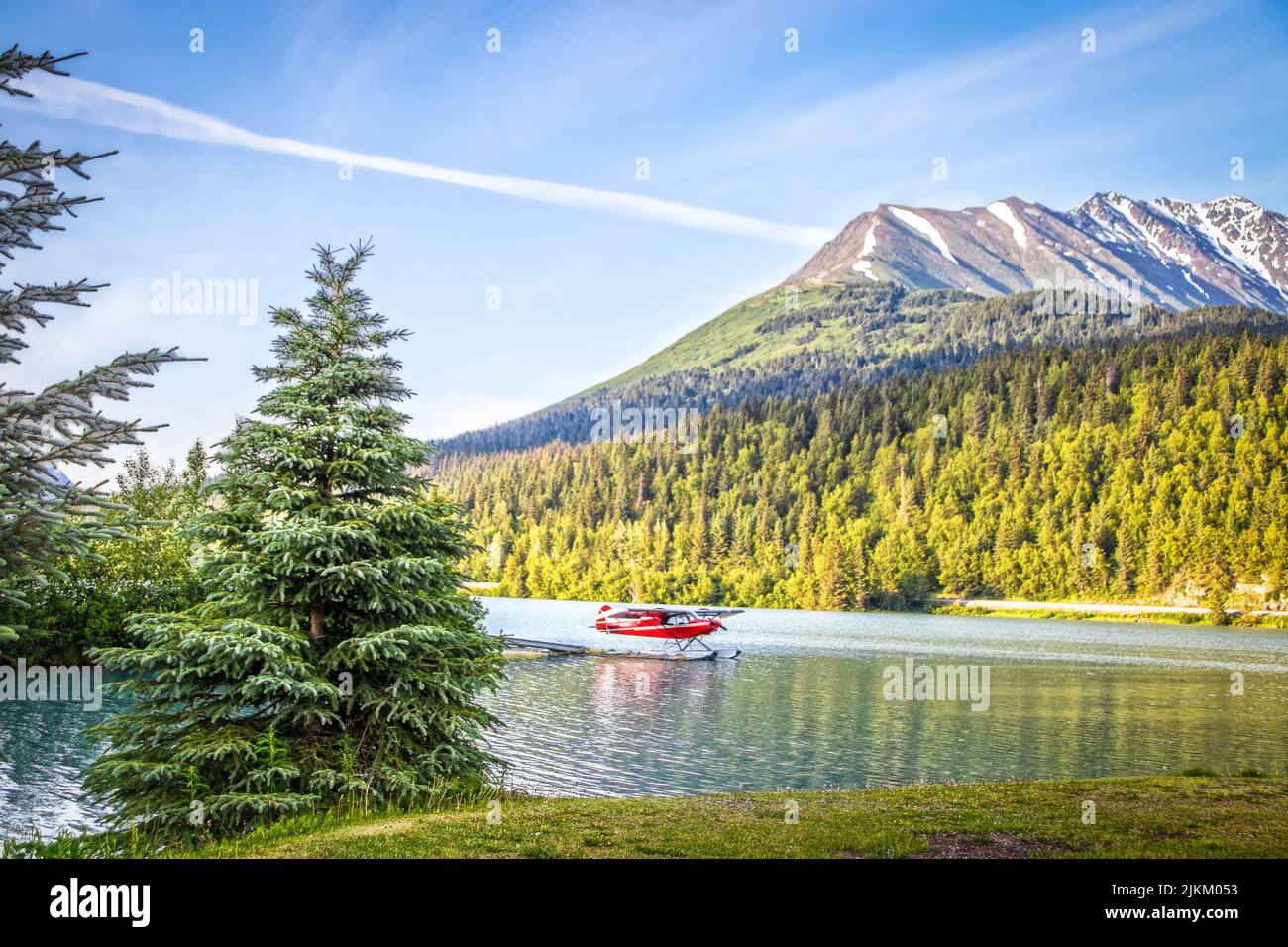 Red float plane parked on the waters of Upper Trail Lake on the Kenai ...