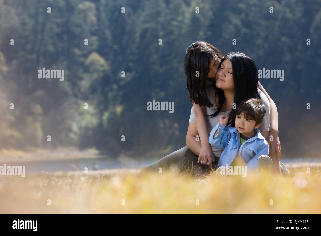 Mexican mother with daughter and son hugging outdoors Stock Photo - Alamy