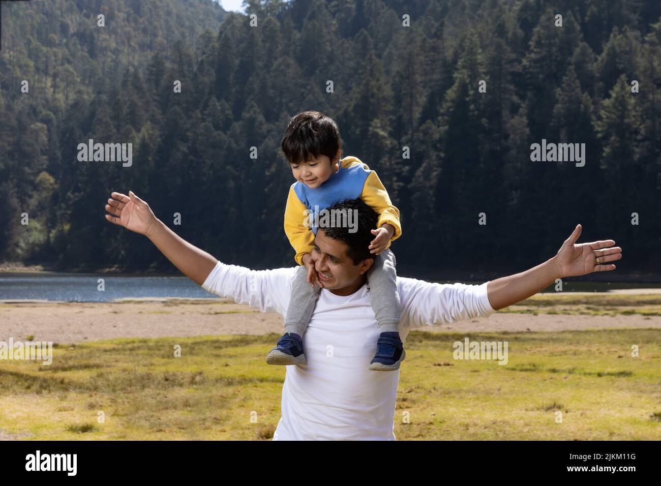 Mexican father and son having fun outdoors Stock Photo - Alamy