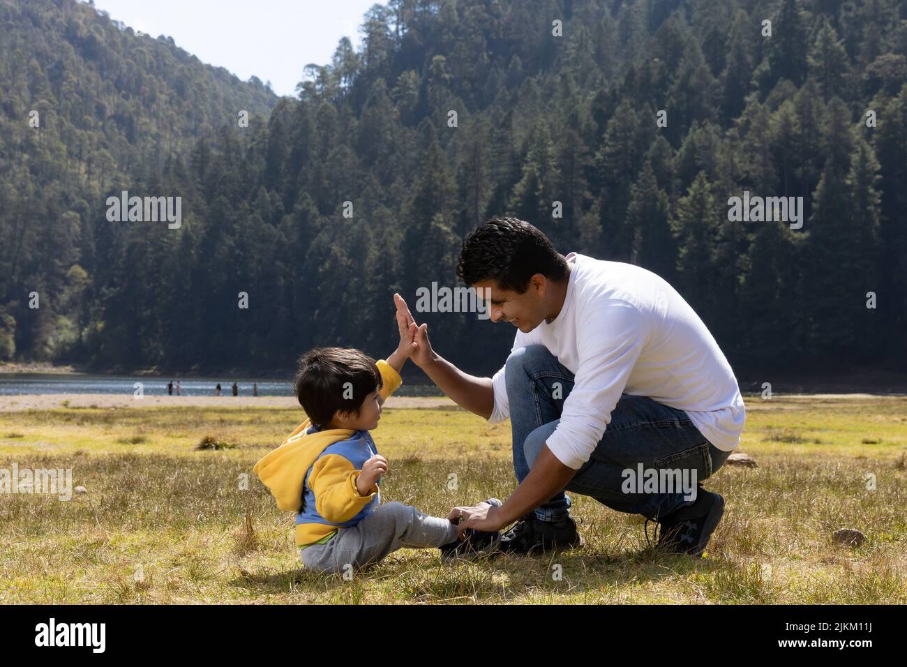 Mexican father and son having fun outdoors Stock Photo - Alamy