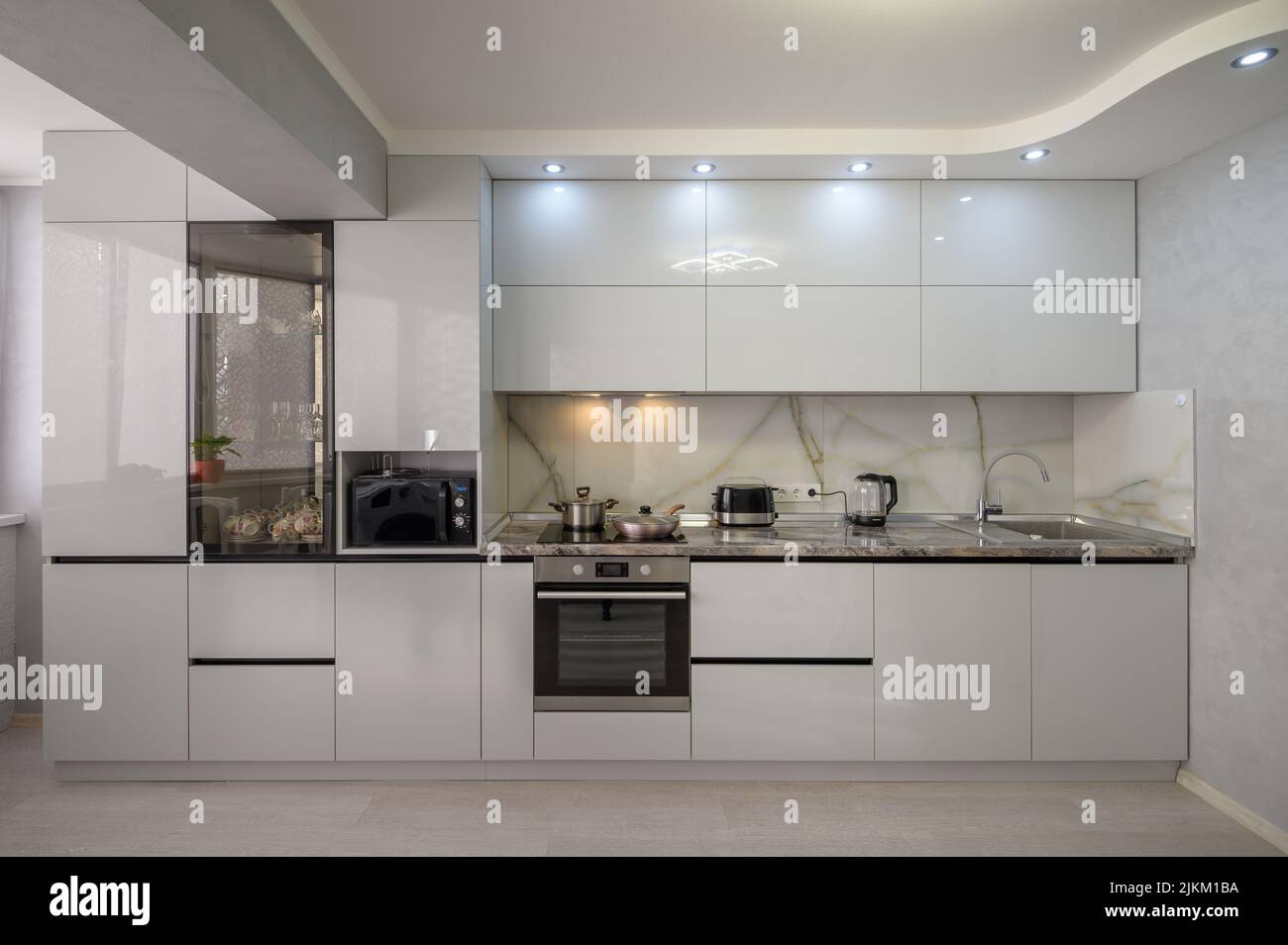 Interior of modern trendy white kitchen, front view Stock Photo - Alamy