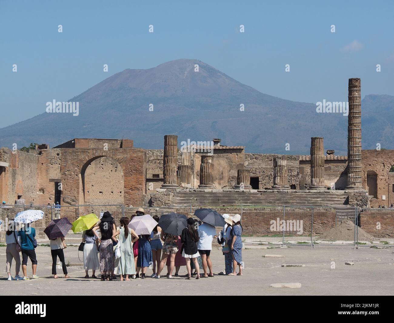 Group of Asian tourists with parasols at Pompei Scavi, the Pompeii ...