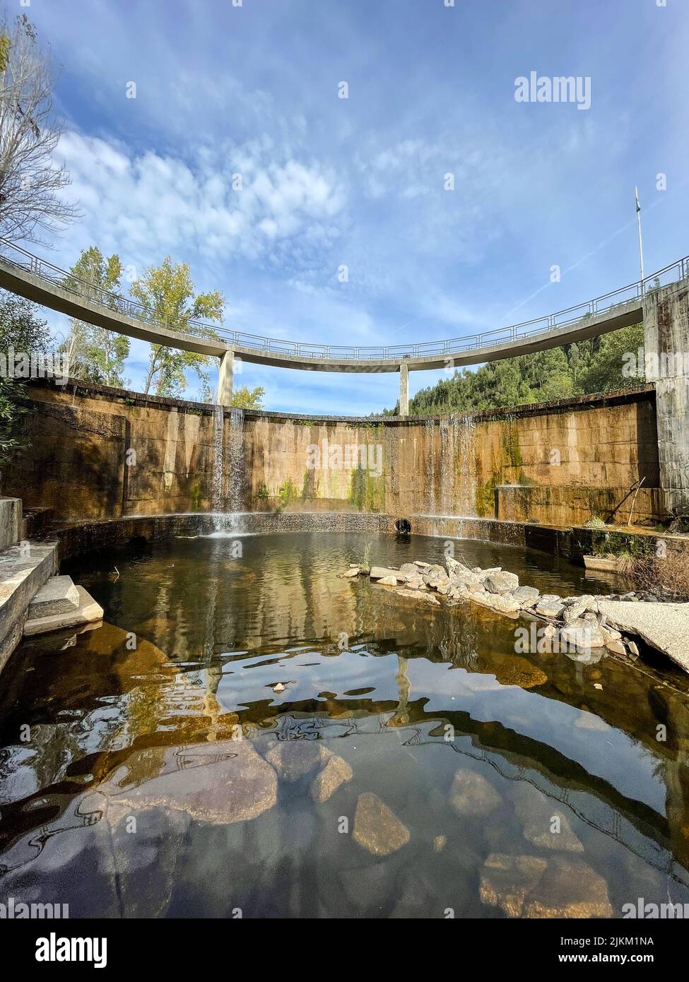 An outdoor view of a calm pond in the backyard under a wispy sky Stock ...