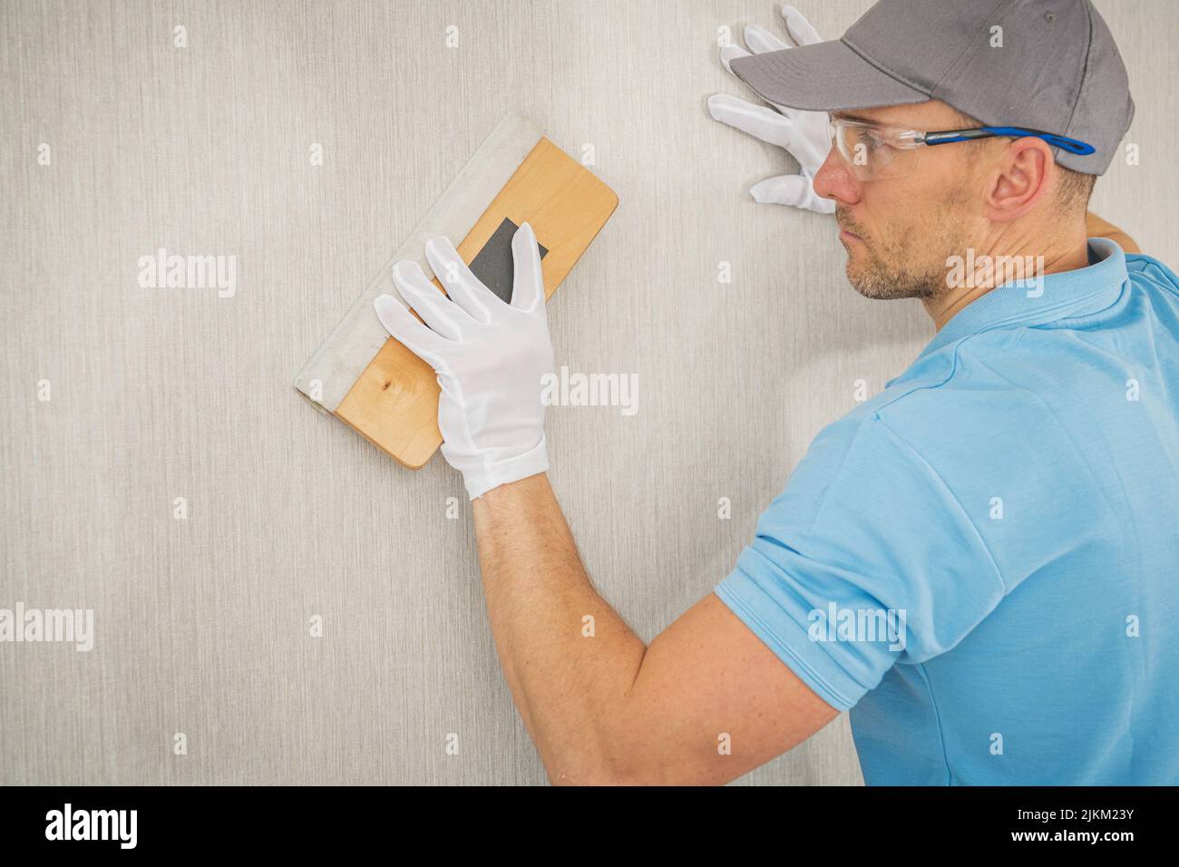 Caucasian Worker in His 40s Softly Applied Modern Vinyl Wallpaper Using ...