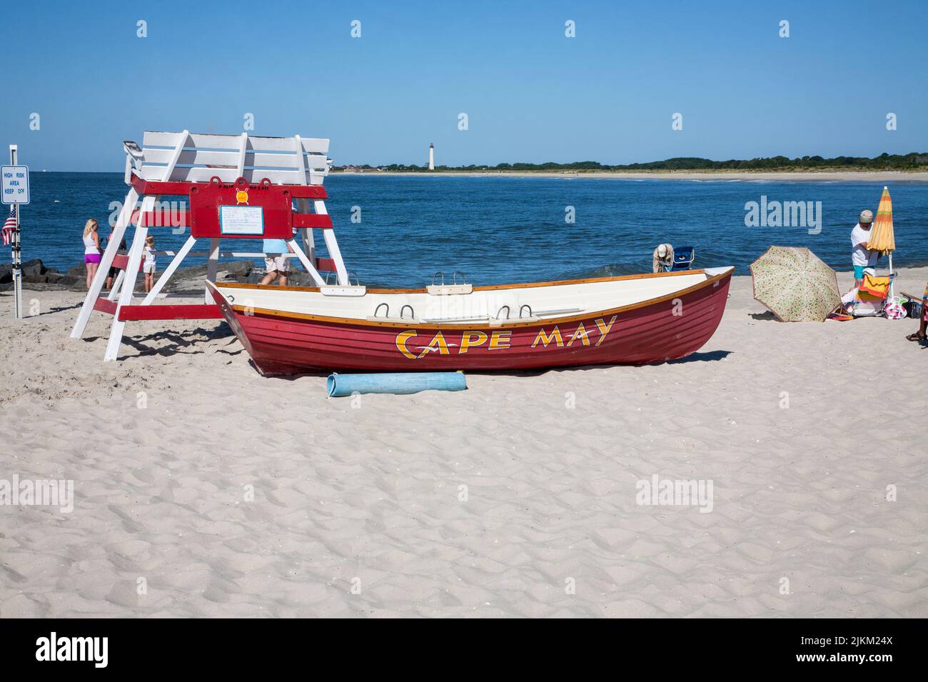 Beach rescue row boat & lifeguard stand, Cape May lighthouse seen at a ...