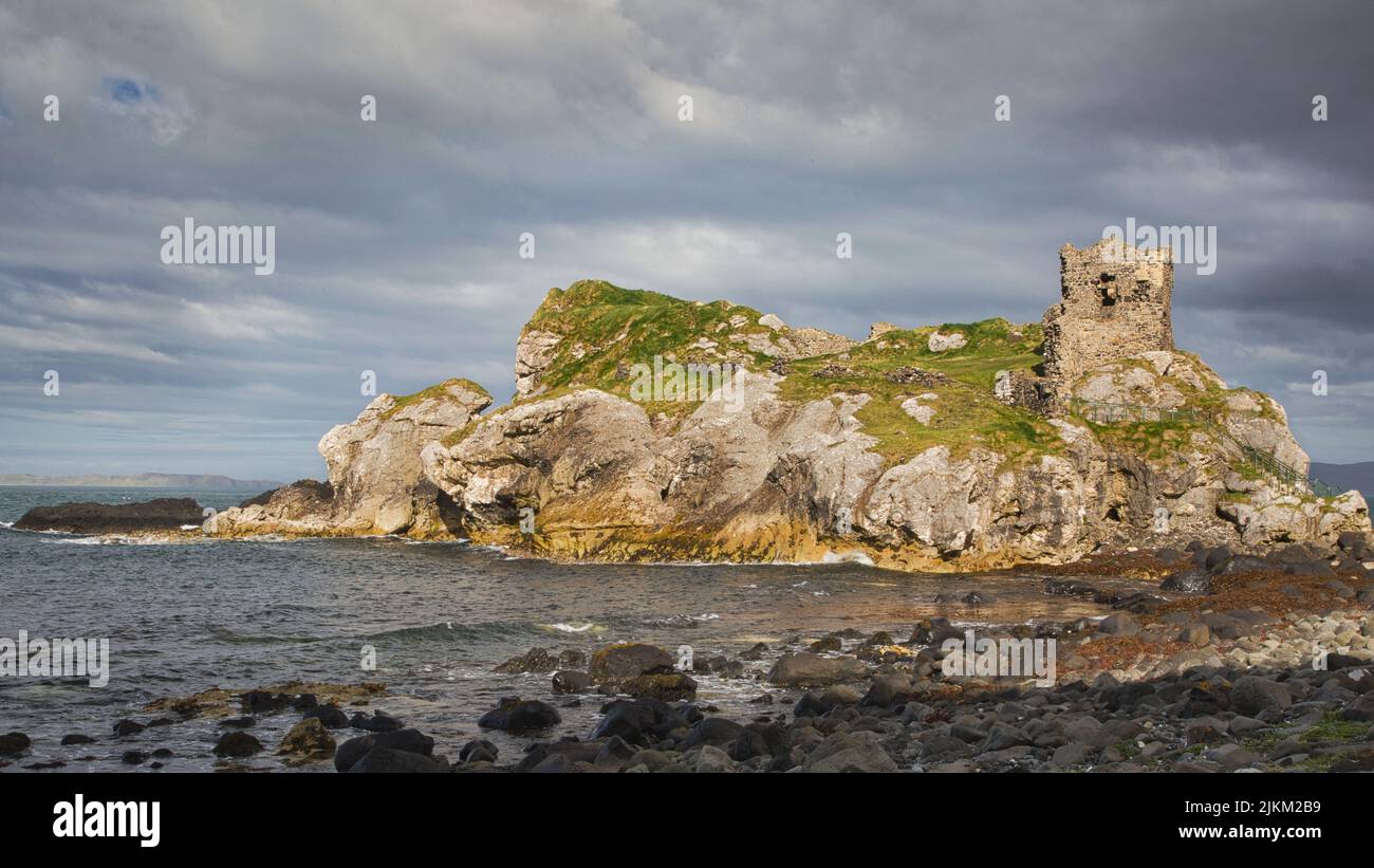 The remains of a small castle on a rock outcrop of the Atlantic coast ...