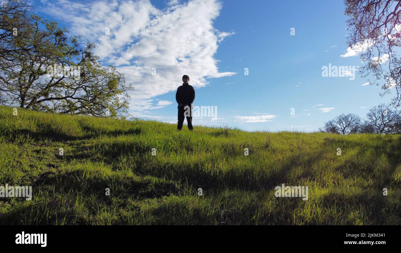 A back view of a male in natural landscape Stock Photo - Alamy