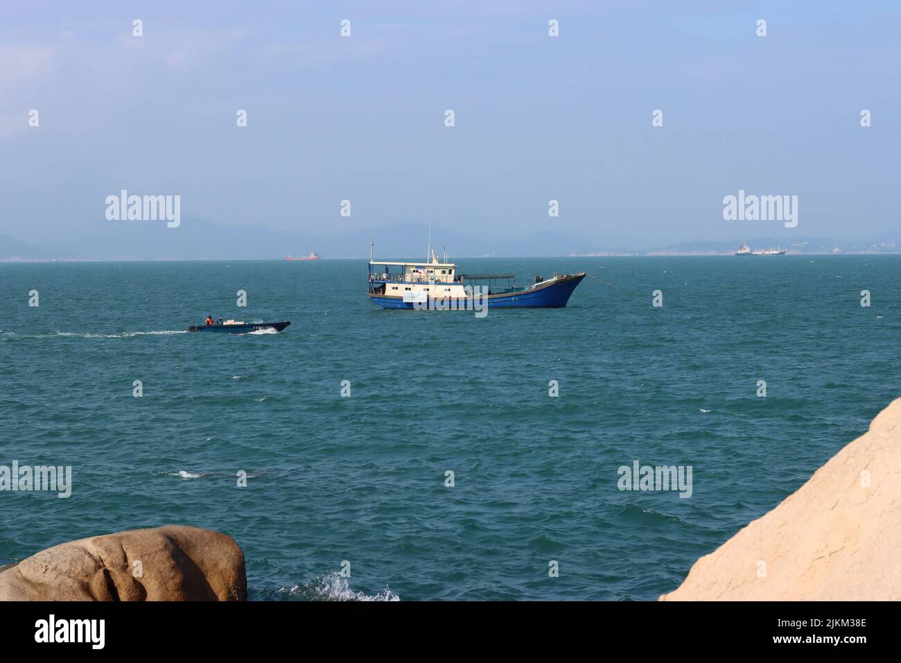A beautiful view of ships sailing in the sea surrounded by cliffs Stock ...