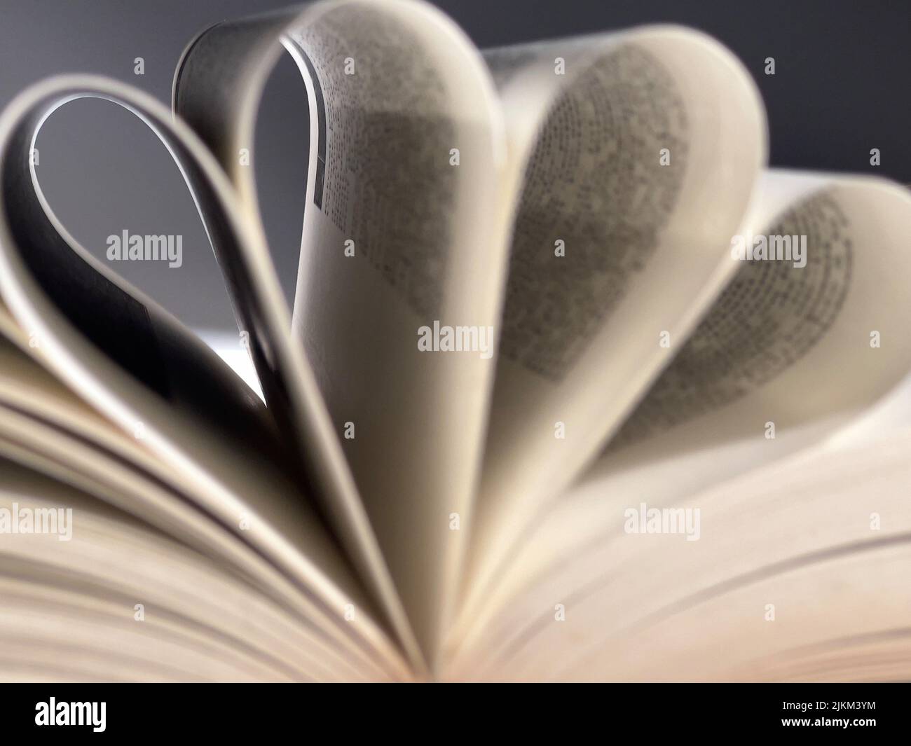 A closeup of an open book with pages folded into heart shape Stock ...