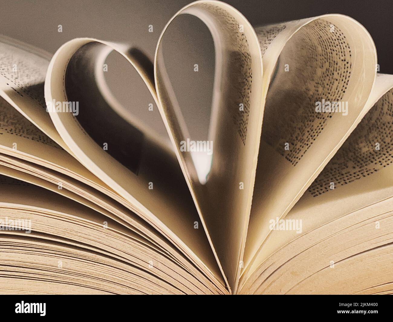 A closeup of an open book with pages folded into heart shape Stock ...