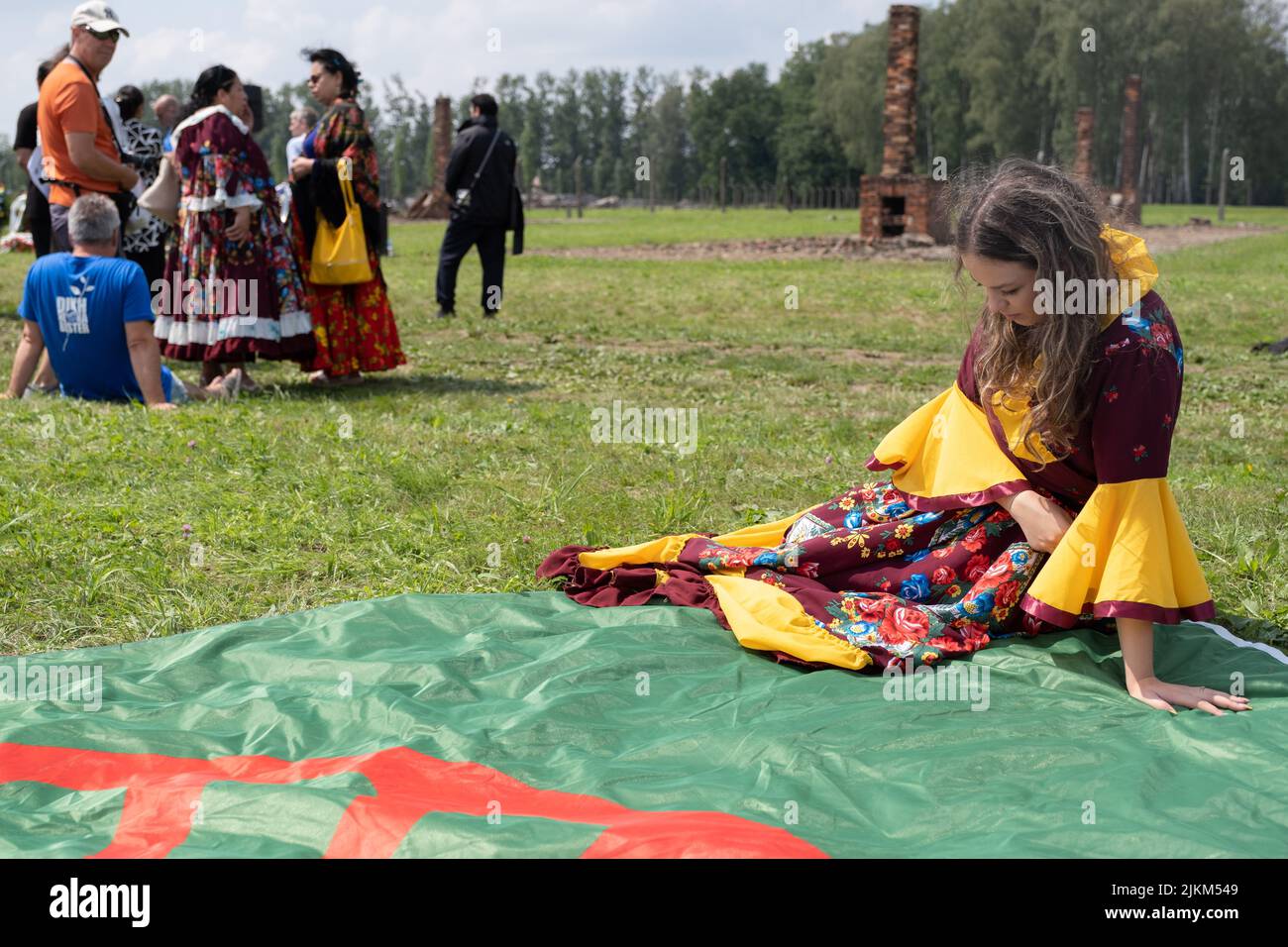 Brzezinka, Poland. 02nd Aug, 2022. A Gypsy girl seen sitting on a flag ...