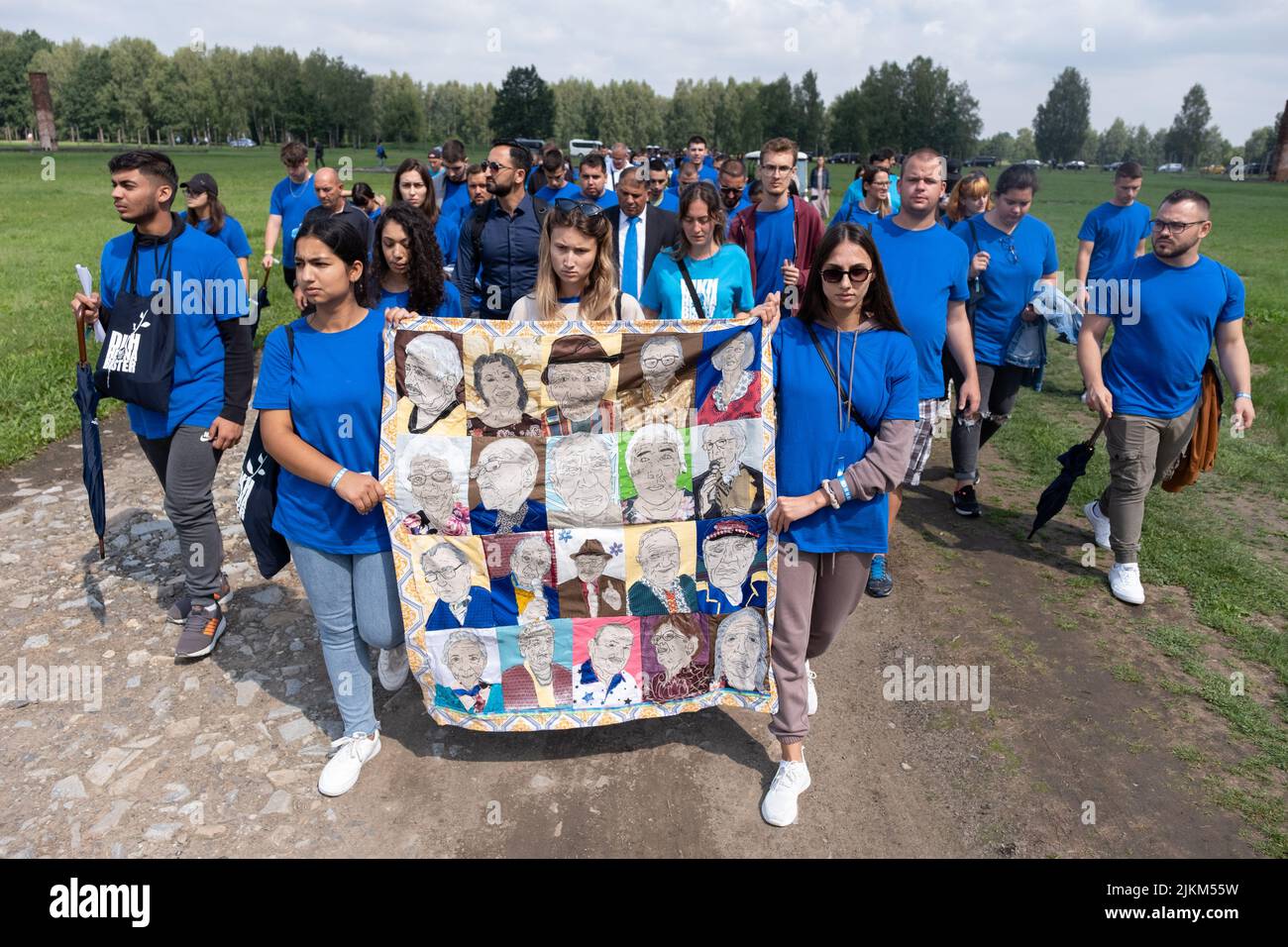 Brzezinka, Poland. 02nd Aug, 2022. A group of Gypsies holding a poster ...