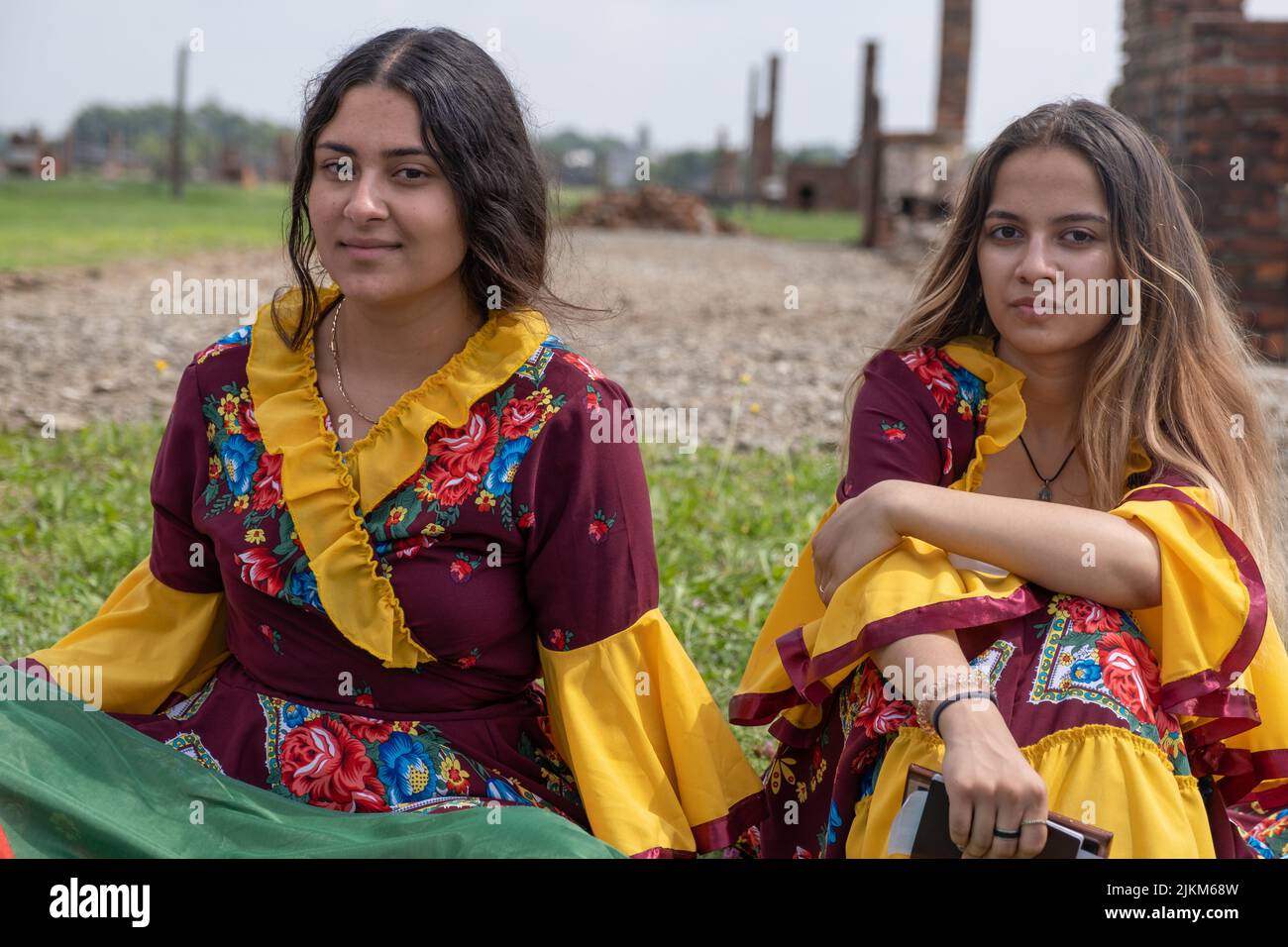Gypsy girls seen sitting on the grass at the former camp Auschwitz II Birkenau. Roma and Sinti ...