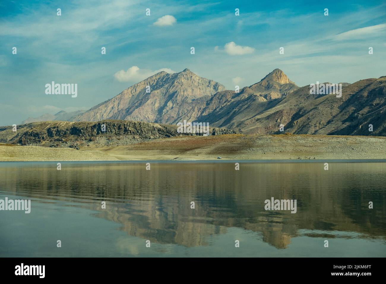 A scenic view of a small body of water reflecting the surrounding ...