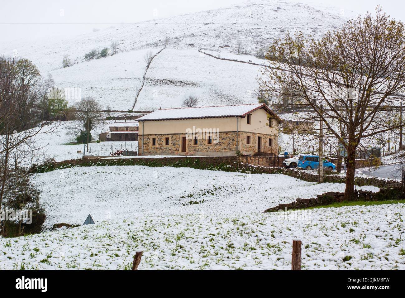 A winter view of a rural area with a small building in the background ...