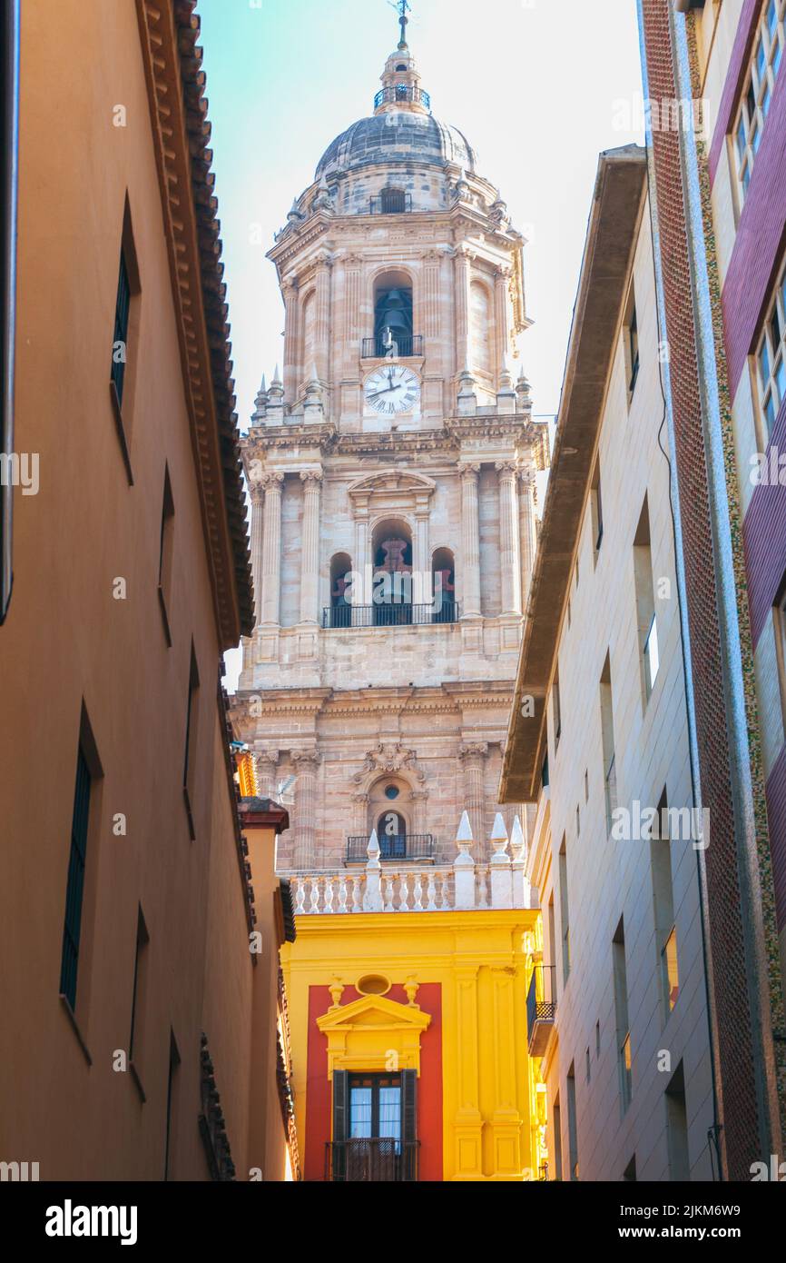 A vertical shot of the part of Malaga cathedral from a narrow alley ...