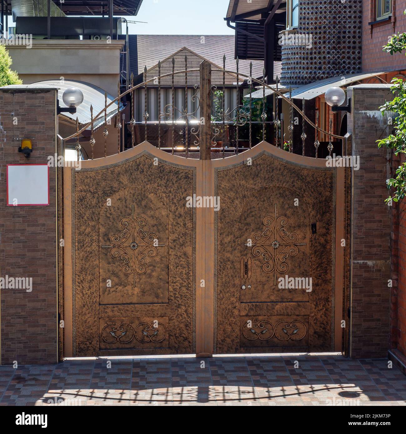 Golden forged openwork gates enclose a private mansion Stock Photo - Alamy