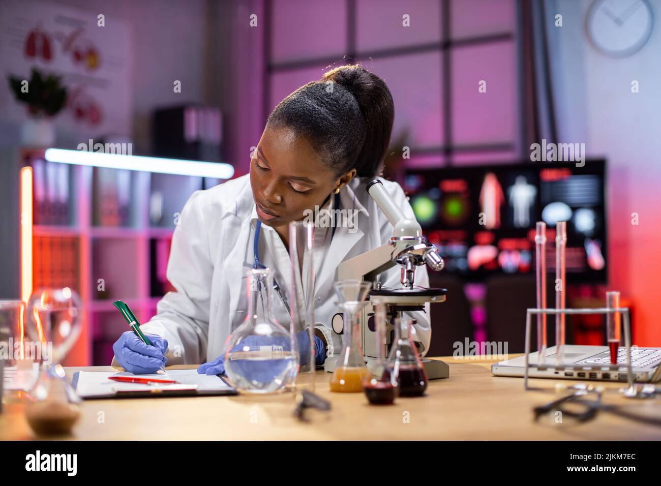 Female african american scientist working in laboratory. Young woman ...