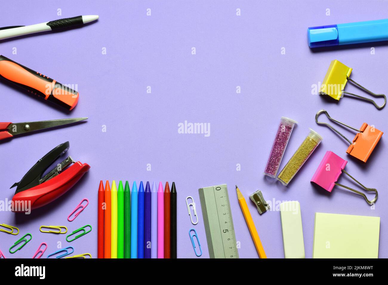 The assorted school supplies on a purple background Stock Photo - Alamy