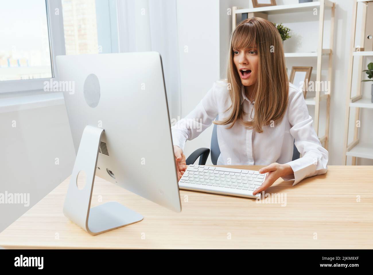 Shocked excited blonde businesswoman hold keyboard confused after ...