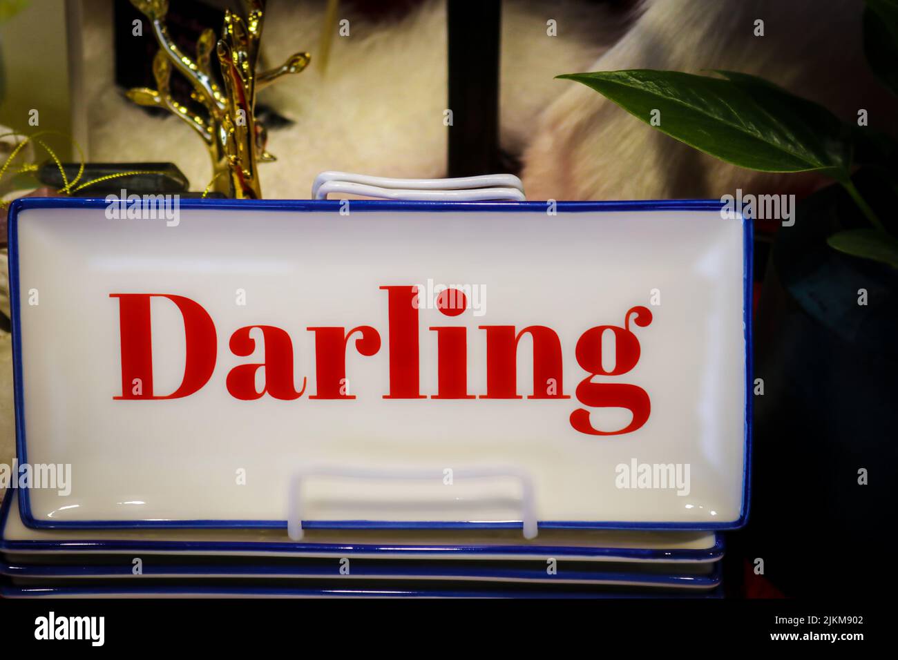 Dearling on a rectangle dish displayed in a store with blurred gold and ...