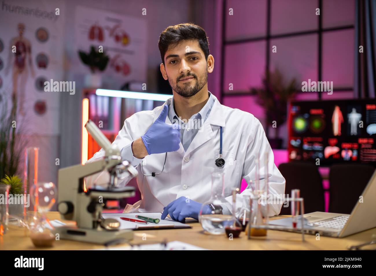 Male scientist working in laboratory. Young indian man researcher ...