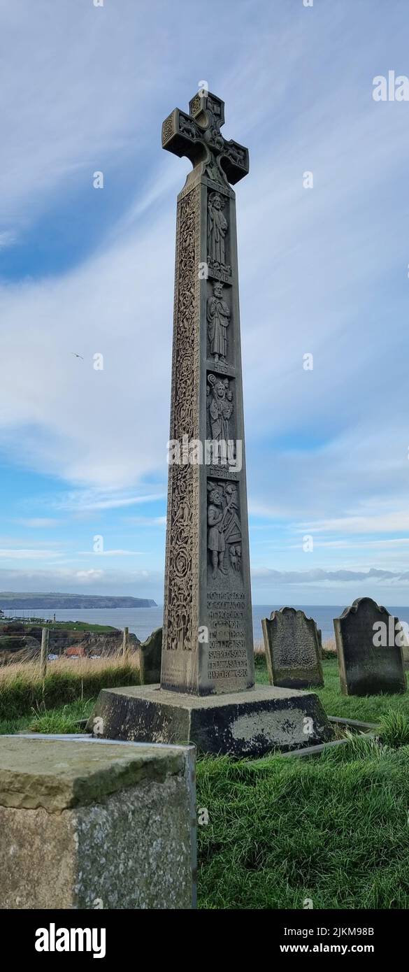 The vertical shot of Caedmon's Cross against the blue sky. Whitby ...