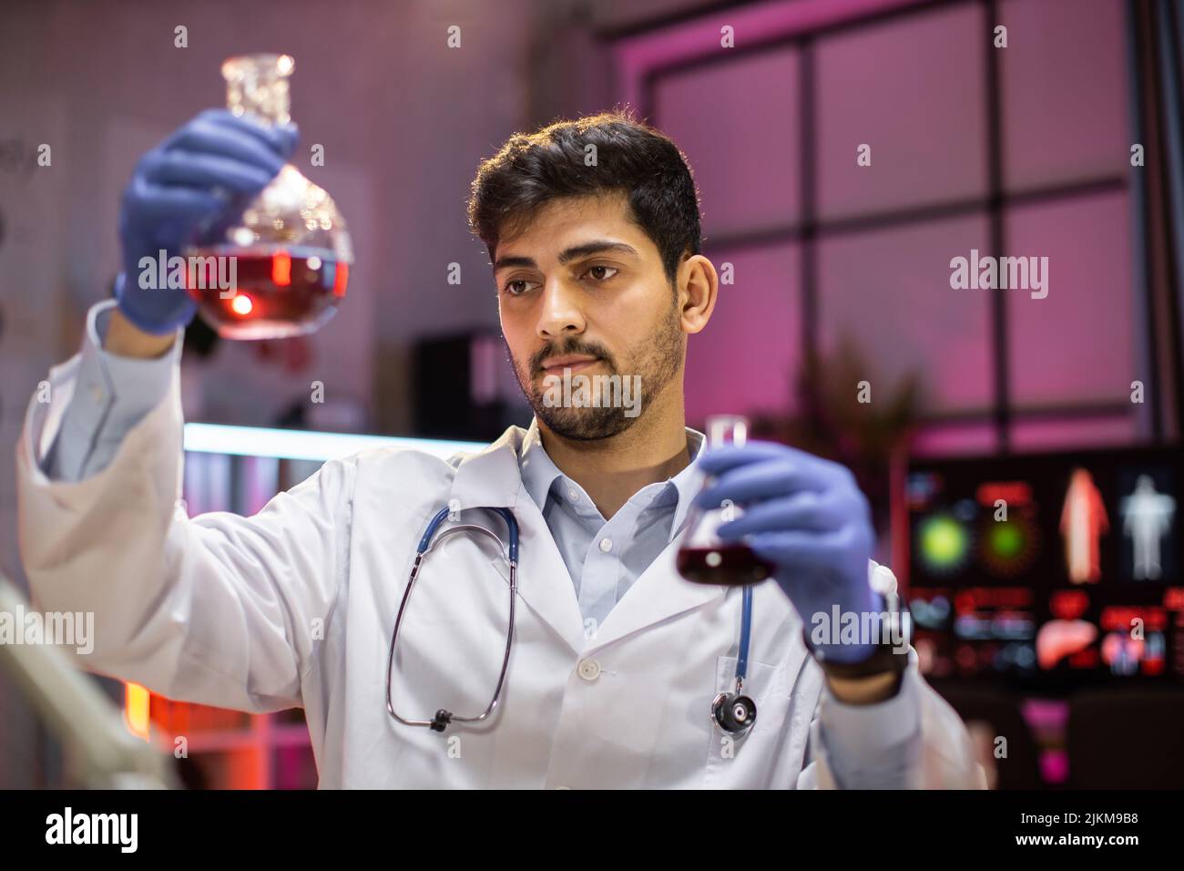 Modern medical research laboratory: indian male scientist working with ... Modern medical research laboratory: indian male scientist working with ...