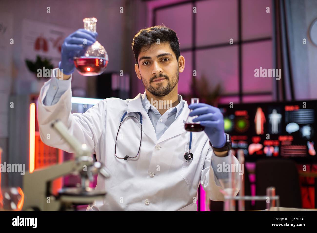 Modern medical research laboratory: indian male scientist working with ... Modern medical research laboratory: indian male scientist working with ...