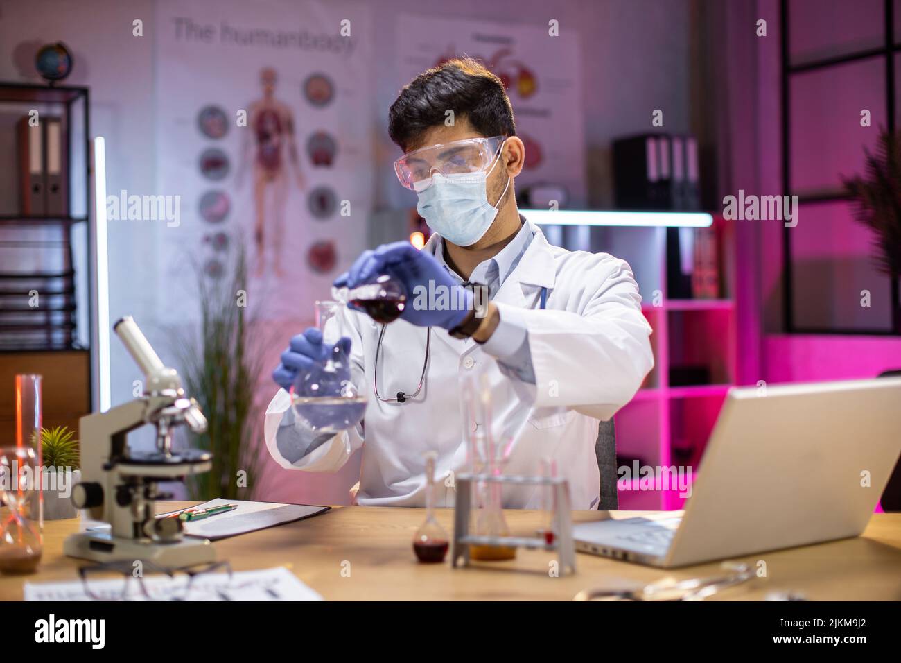 Positive male arab scientist or medical in lab coat holding test tube ...