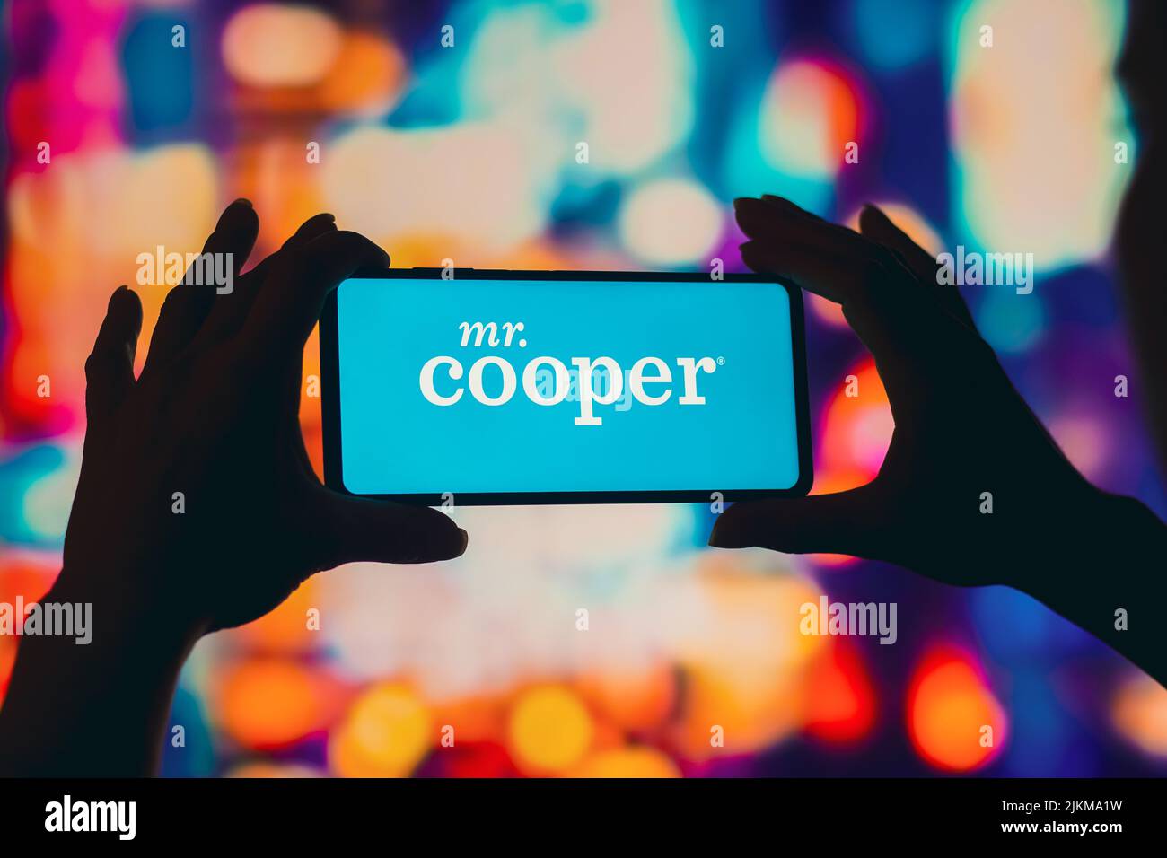 In this photo illustration, a silhouetted woman holds a smartphone with ...