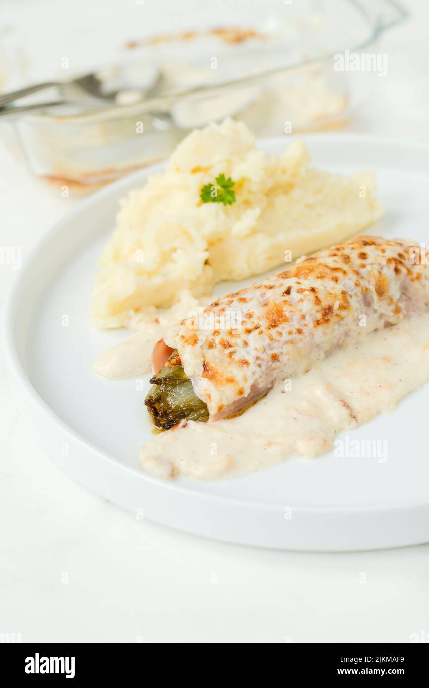 A vertical shot of a Belgian classic dish called Chicon gratin with ...