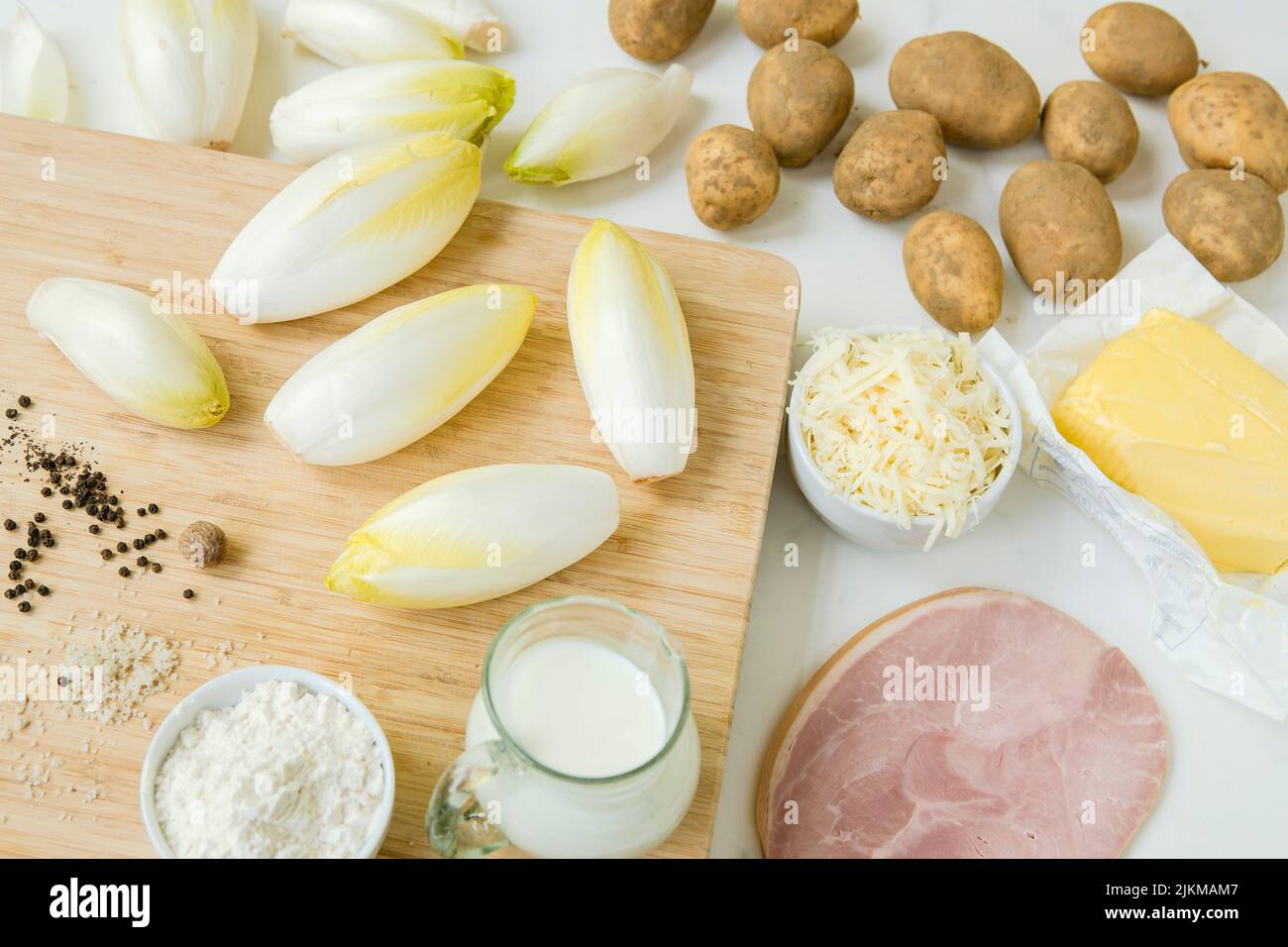 A top view of ingredients of a Belgian classic dish called Chicon ...