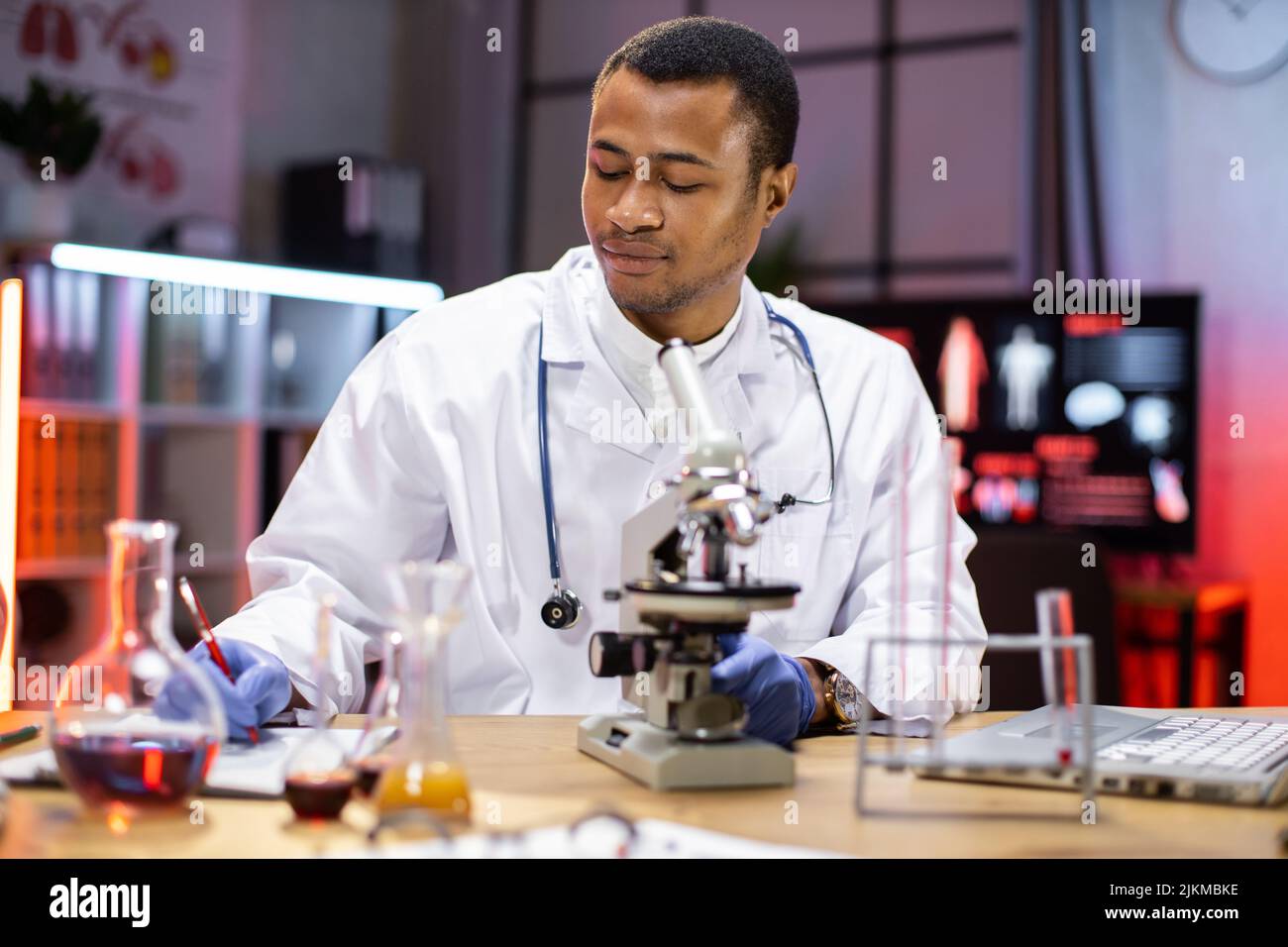 Professional african american man microbiologist or medical worker use ...