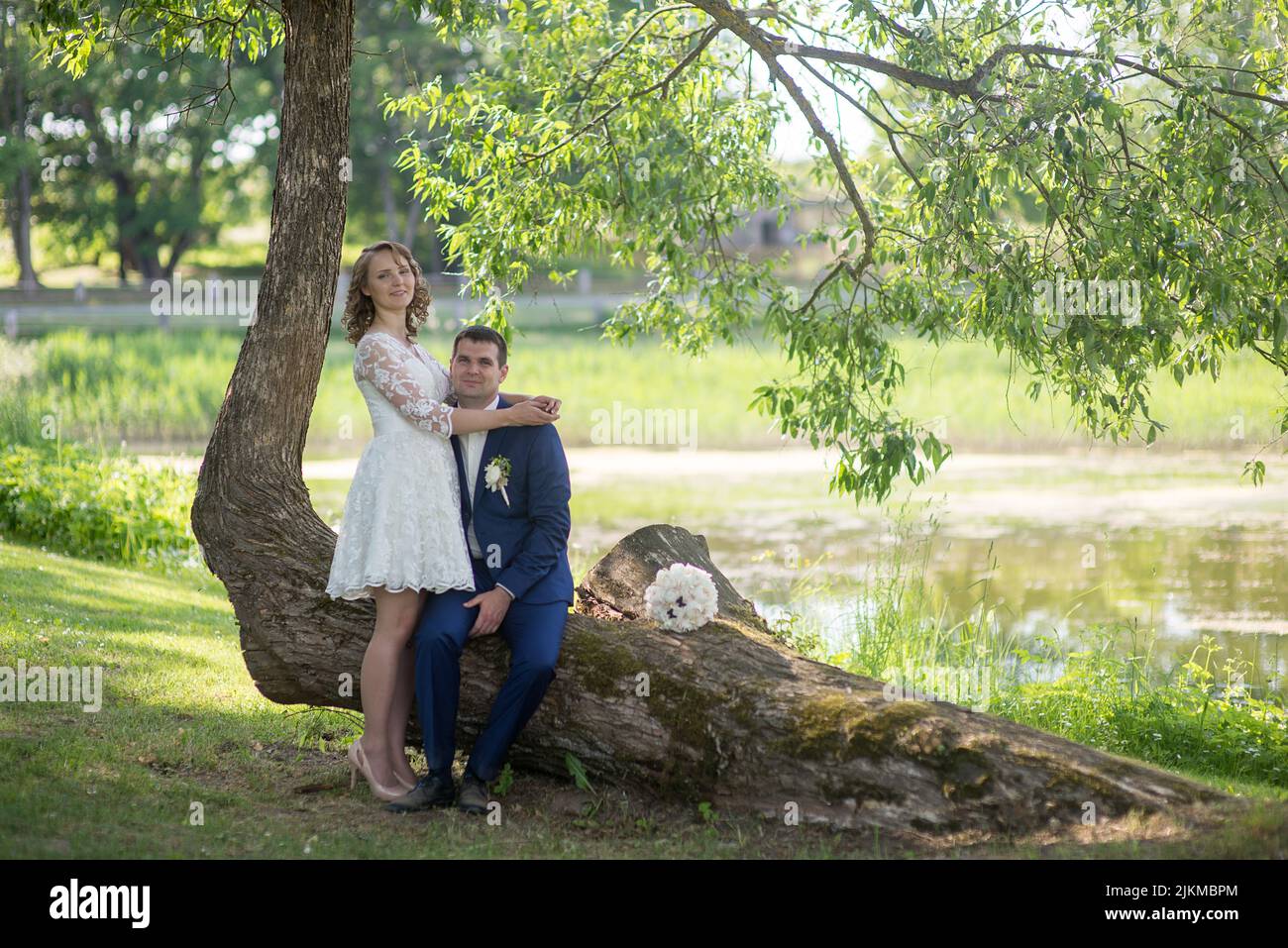 A happy Caucasian newlywed resting under a tree Stock Photo - Alamy