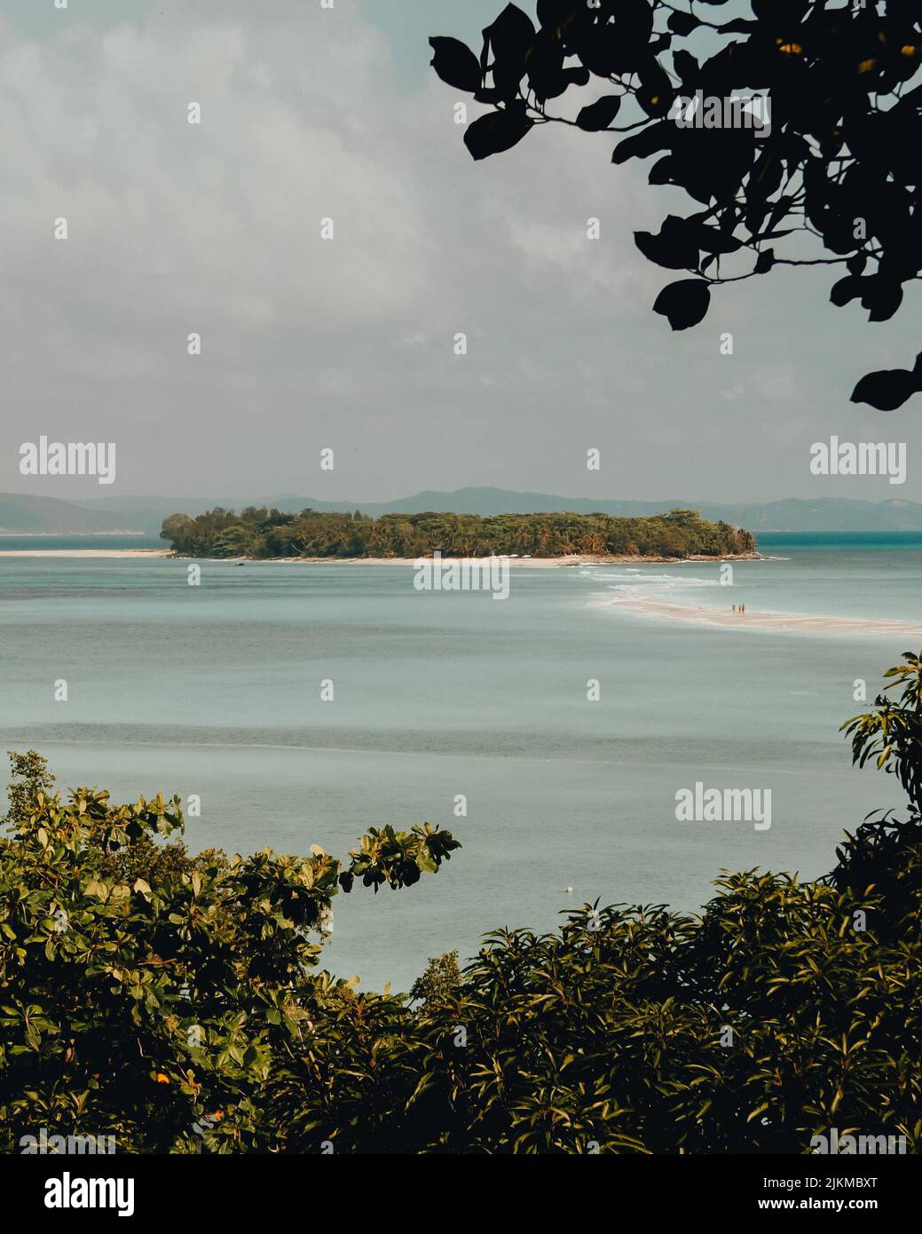 A vertical shot of an island seen behind the trees Stock Photo - Alamy