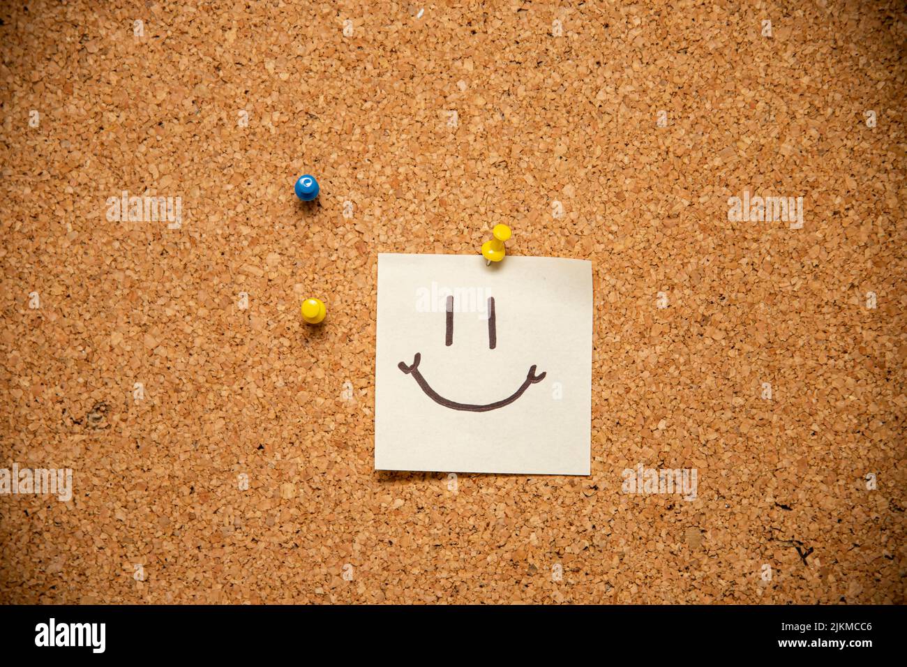 A closeup shot of a smiley face on an attached sticky note Stock Photo ...