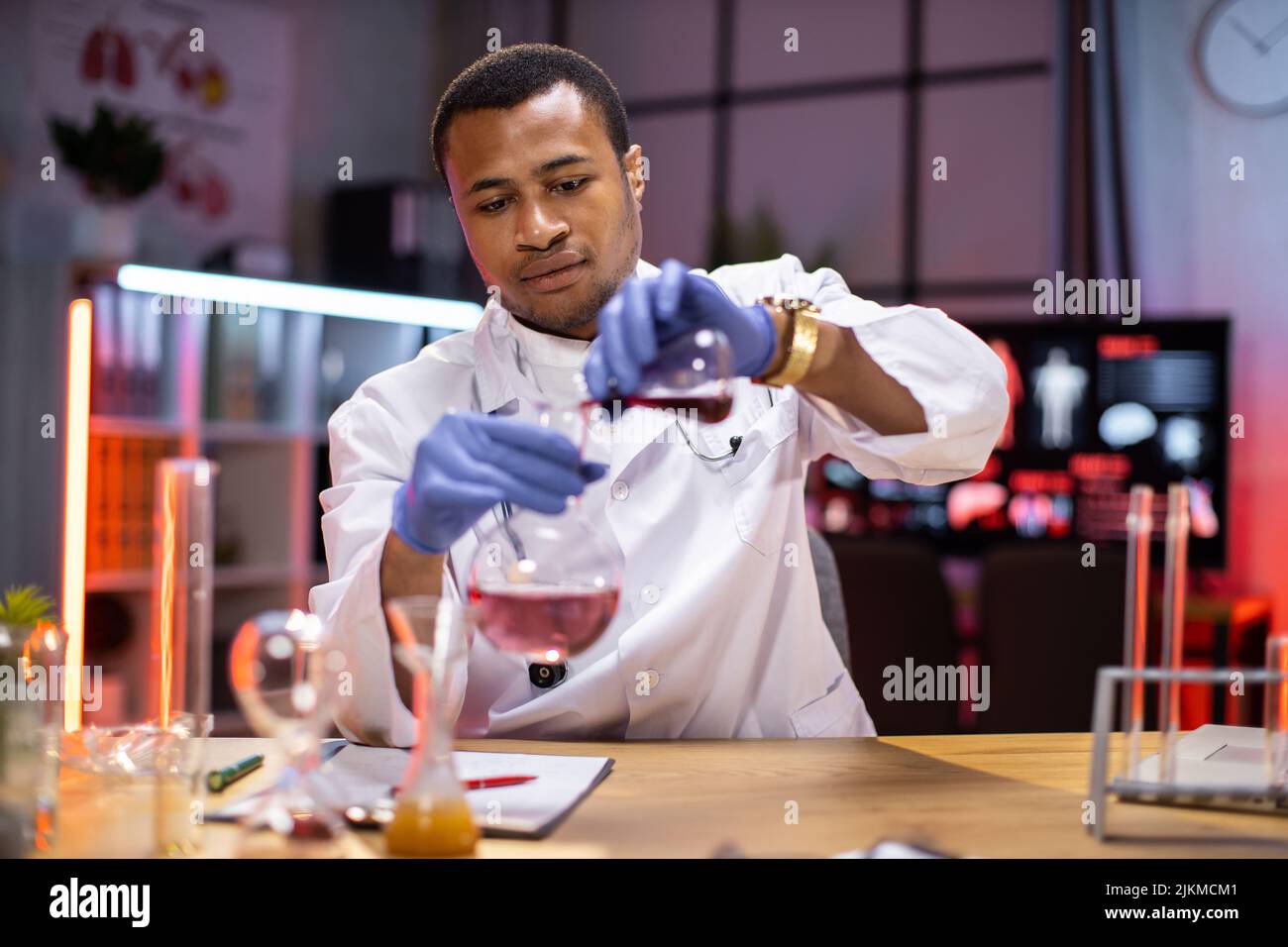 Experienced male scientist in health industry doing analysis of ...