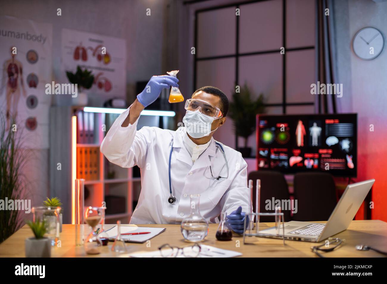 Young scientist african man lab technical service holding flask with ...
