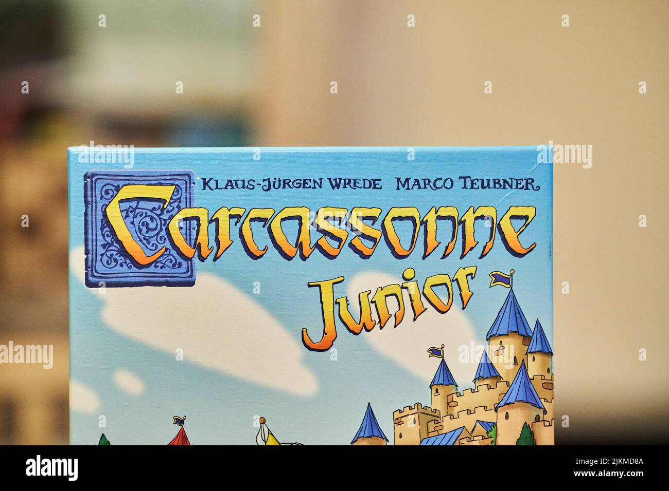 A closeup shot of a Carcassonne Junior game in a box against a blurred ...