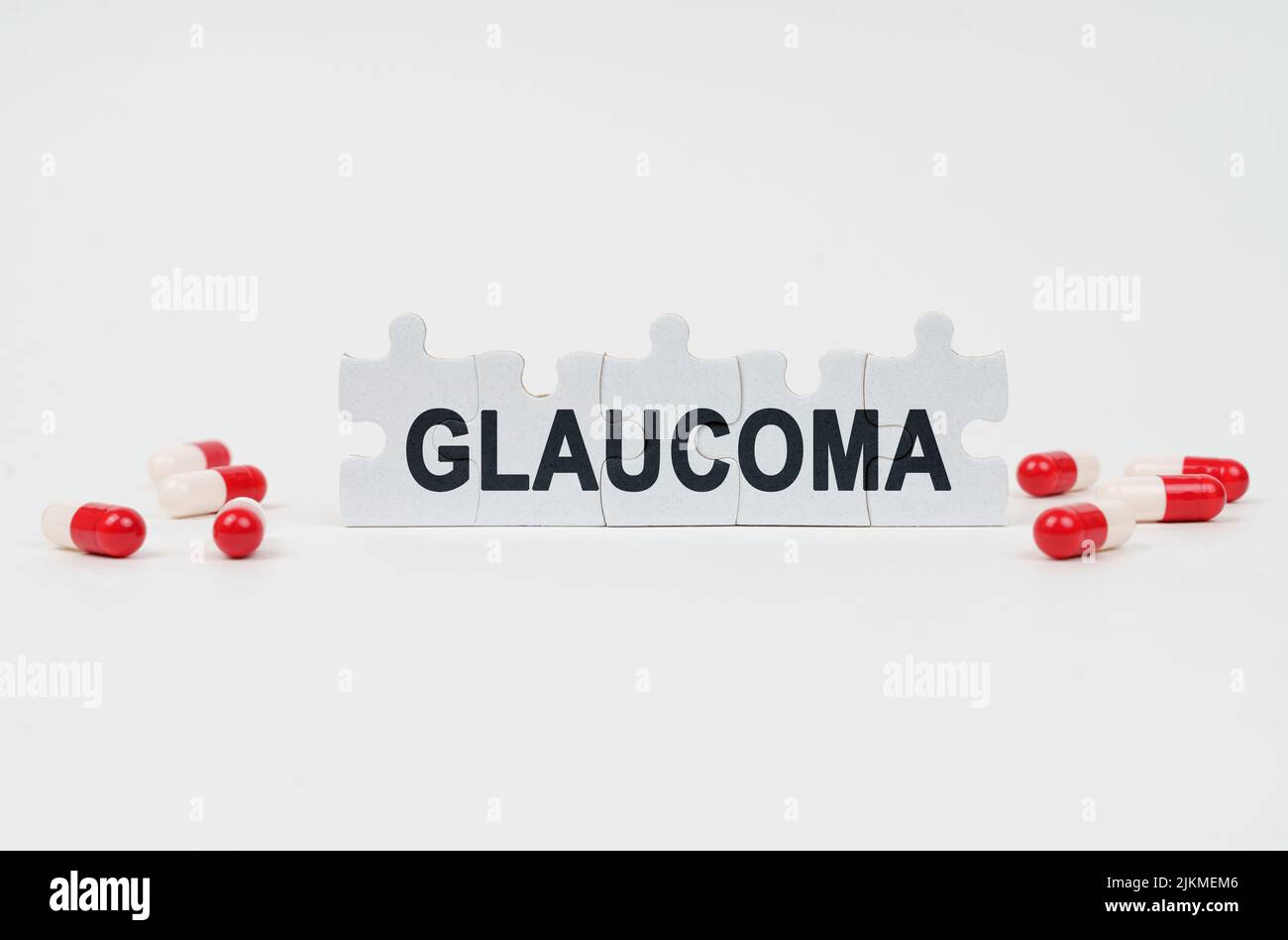 Medical concept. On a white surface are tablets and puzzles with the ...