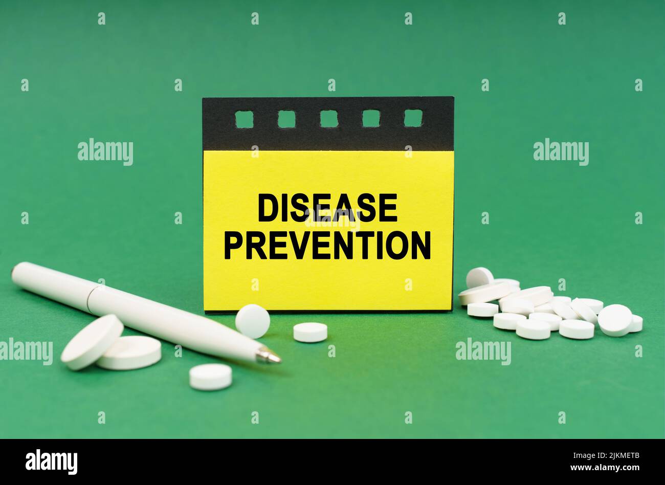 Medical concept. On the green surface are tablets, a pen and stickers ...