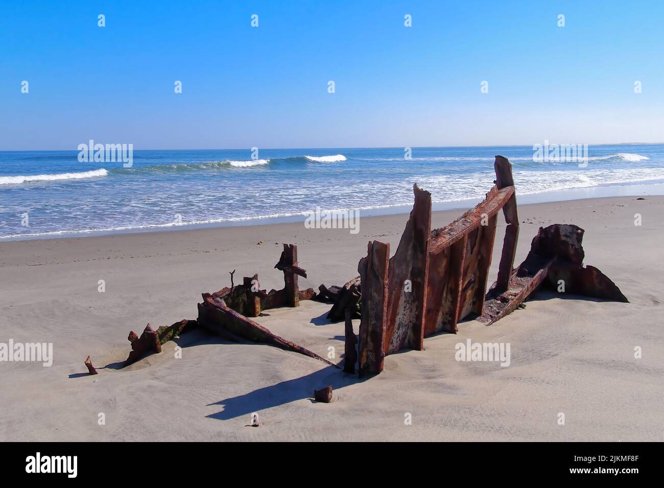 A serene view of scrap metal remains on Skeleton Coast, Namibia Stock ...