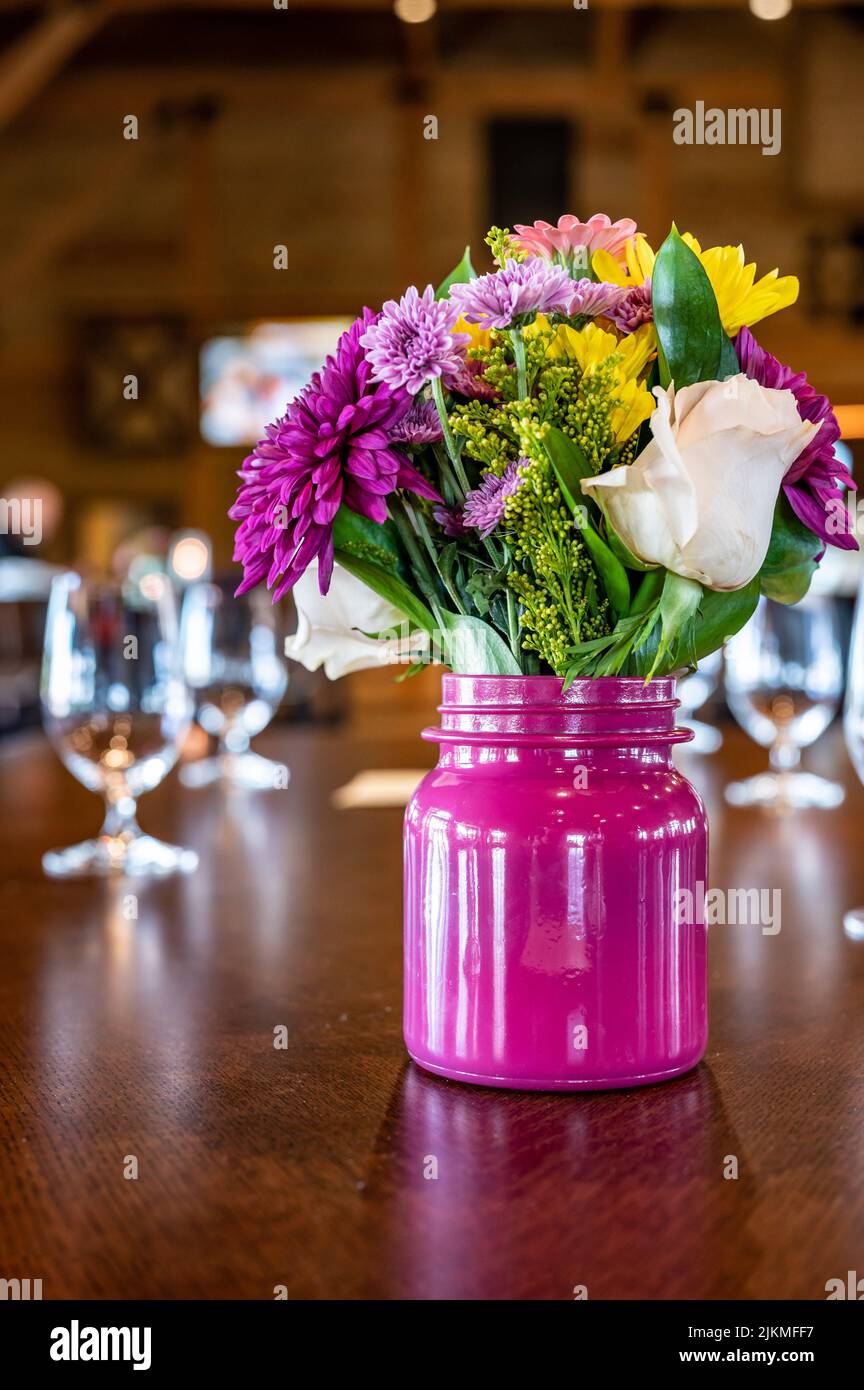 Flower arrangement on a formal dinning table with dim lighting Stock ...