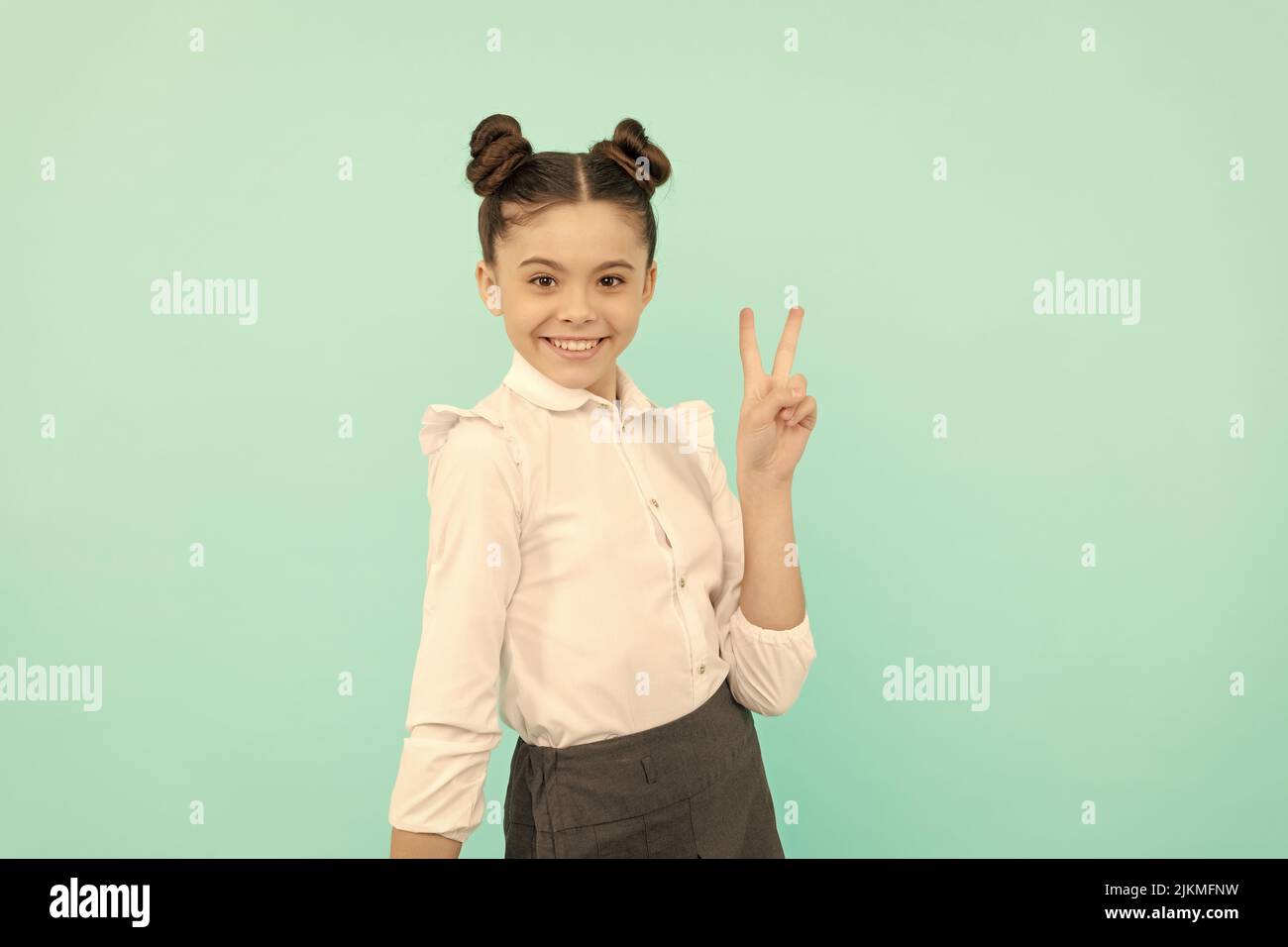 Peace maker. School age kid show V sign. Happy kid blue background ...