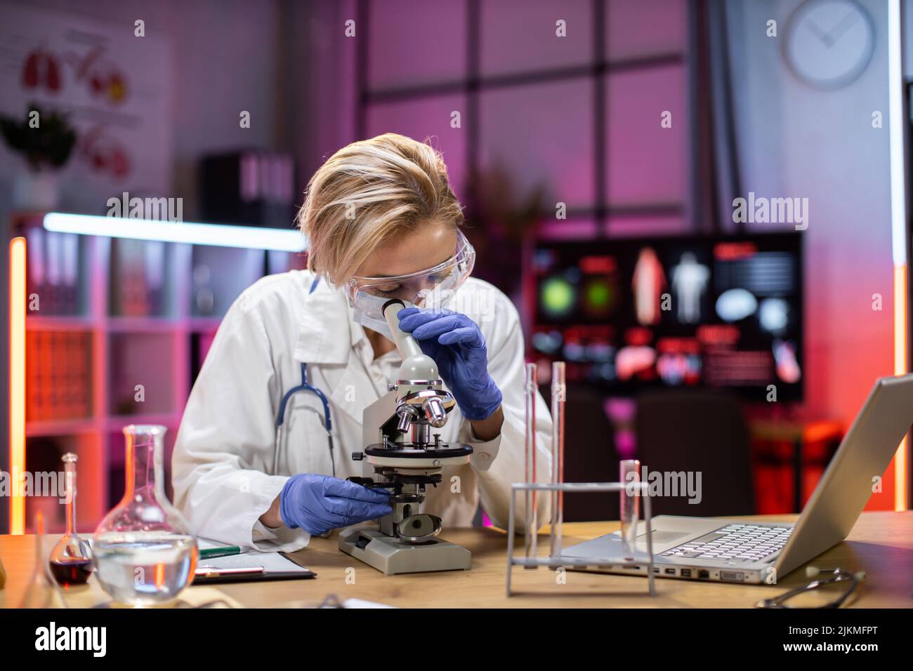 Biochemical research of scientist working with microscope for vaccine ...