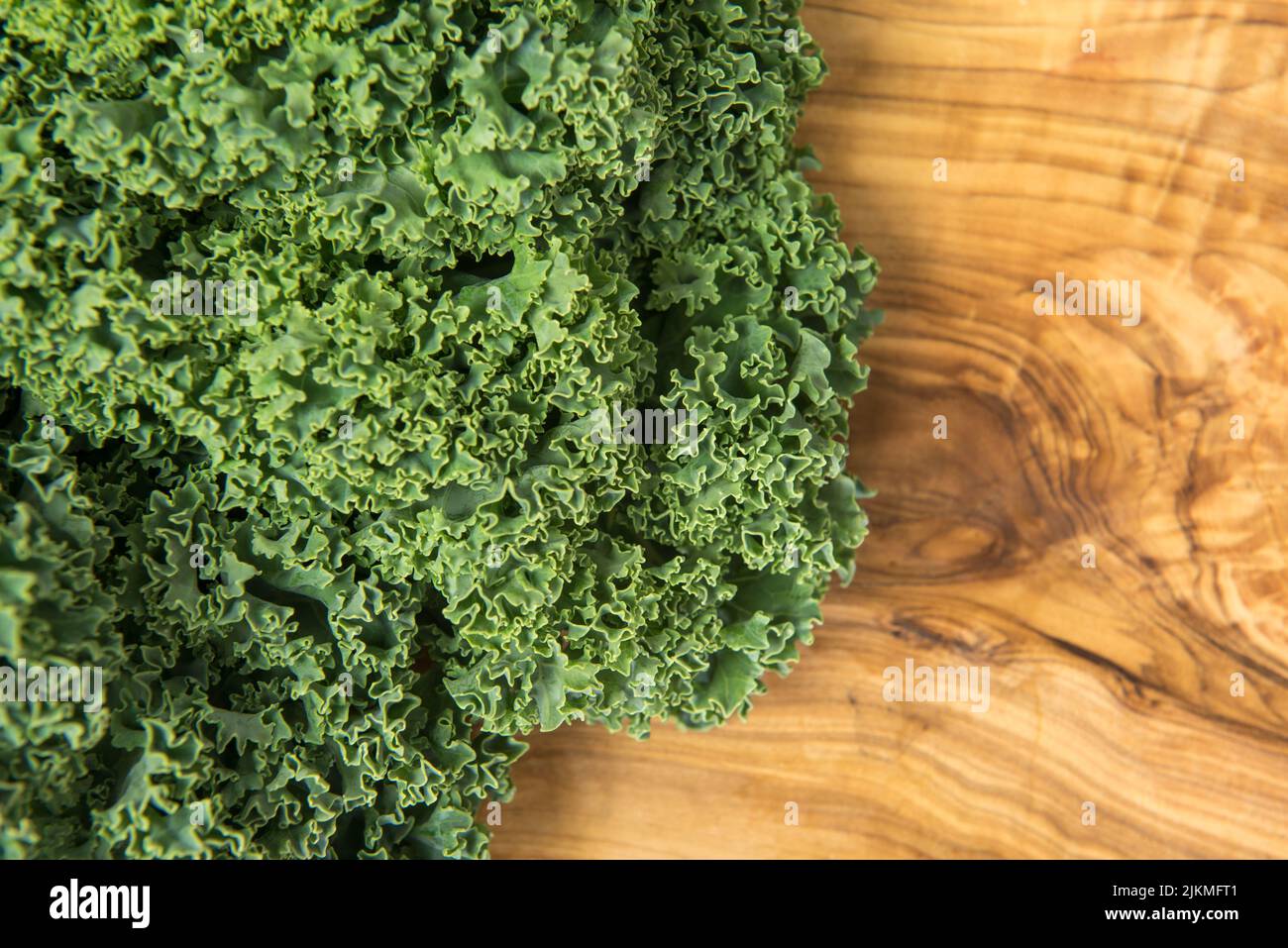 Bunch of organic fresh kale on grainy wooden background Stock Photo - Alamy