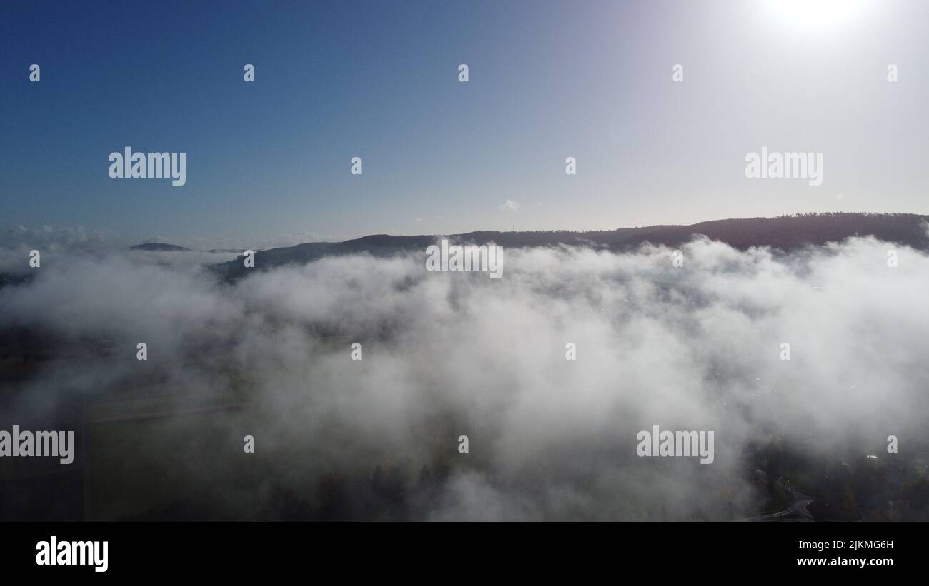 An aerial view of sea of clouds over a vast landscape Stock Photo - Alamy