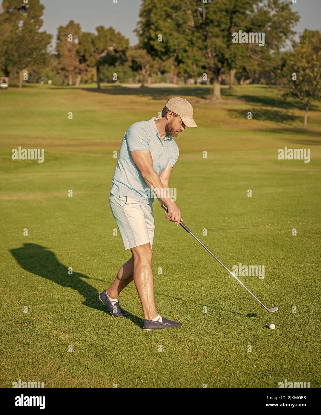 male golf player on professional golf course. portrait of golfer in cap ...