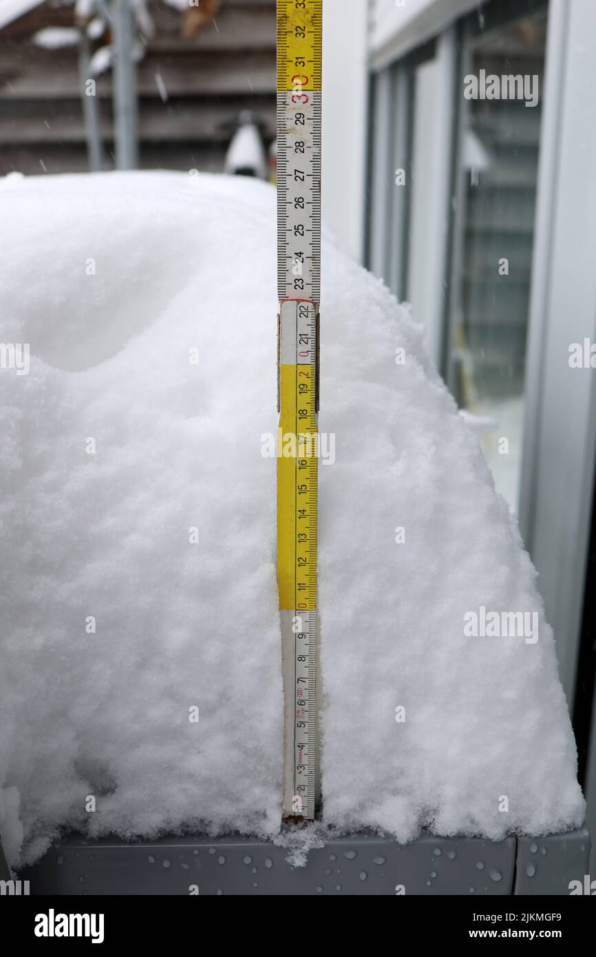 Depth of freshly fallen snow a meter stick Stock Photo - Alamy